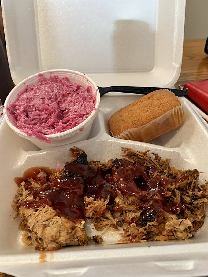 BBQ nirvana on a plate: pulled pork with that perfect bark-to-meat ratio, pink slaw for tang, and cornbread that doesn't need to show off.