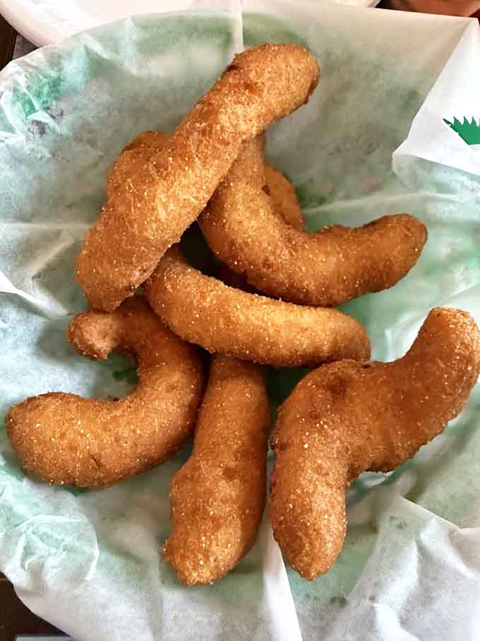 Golden hushpuppies that could make a grown person weep with joy, crispy outside and impossibly fluffy within every bite.