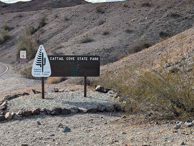 The unassuming entrance to paradise. This modest sign marks the threshold between ordinary desert and extraordinary lakeside wonder.