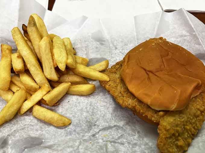 The pork tenderloin sandwich arrives golden and crispy, proving that Midwestern classics deserve way more national attention than they get.