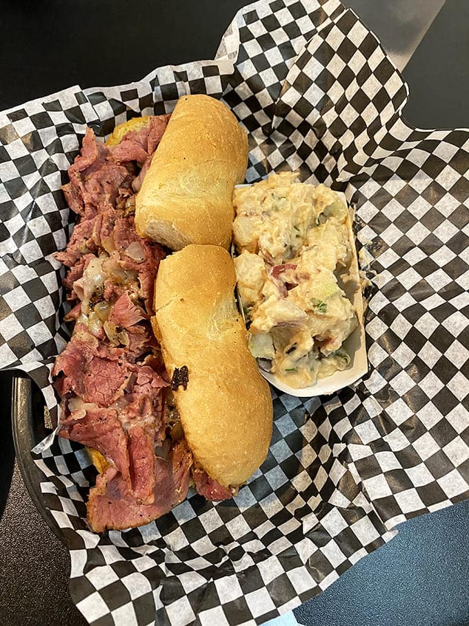 The star of the show: tender tri-tip spilling out of a perfectly toasted roll with potato salad standing by. This isn't a sandwich&mdash;it's an event.