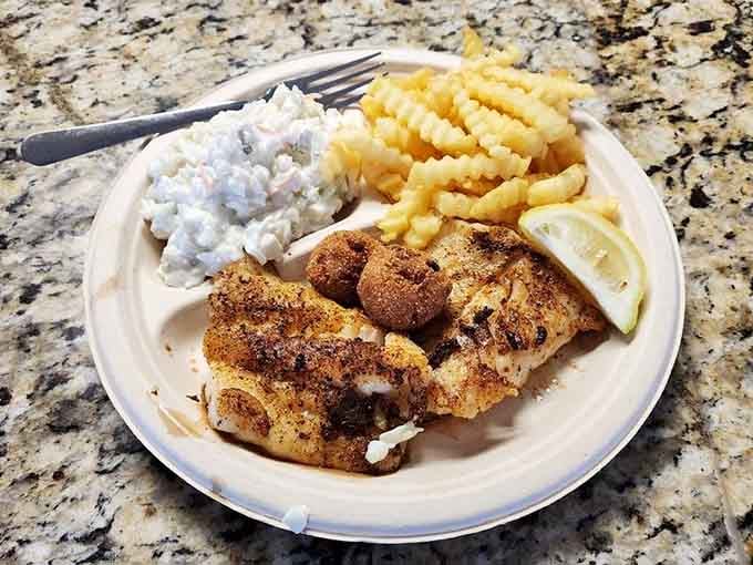 Blackened grouper with hushpuppies and waffle fries proves that sometimes the simplest combinations create the most memorable meals.