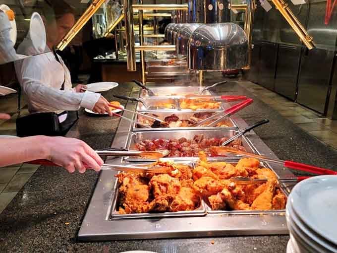 Golden fried chicken glistening under the buffet lights like edible treasure waiting to be claimed by your eager plate.