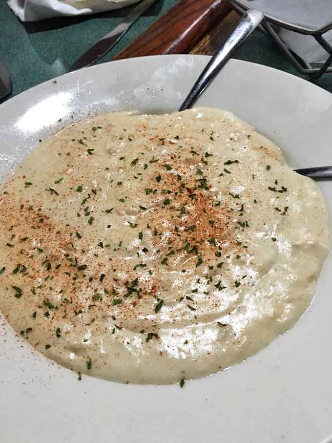 The legendary She Crab Soup arrives like a creamy ocean dream, sprinkled with spices and herbs&mdash;proof that heaven sometimes comes in bowl form.
