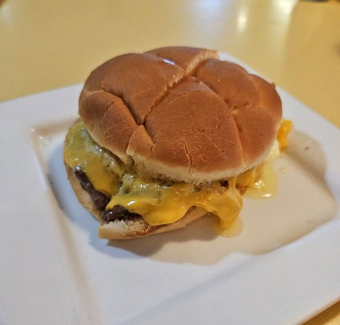 Behold the glistening crown jewel: melted butter cascading over a perfectly grilled patty like liquid gold finding its destiny.