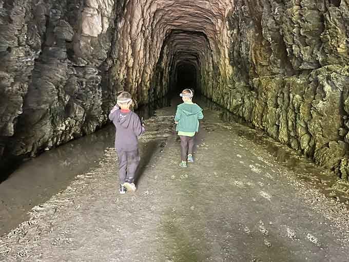 Young explorers venture into the cool depths, flashlights in hand, ready for their own Indiana Jones moment.