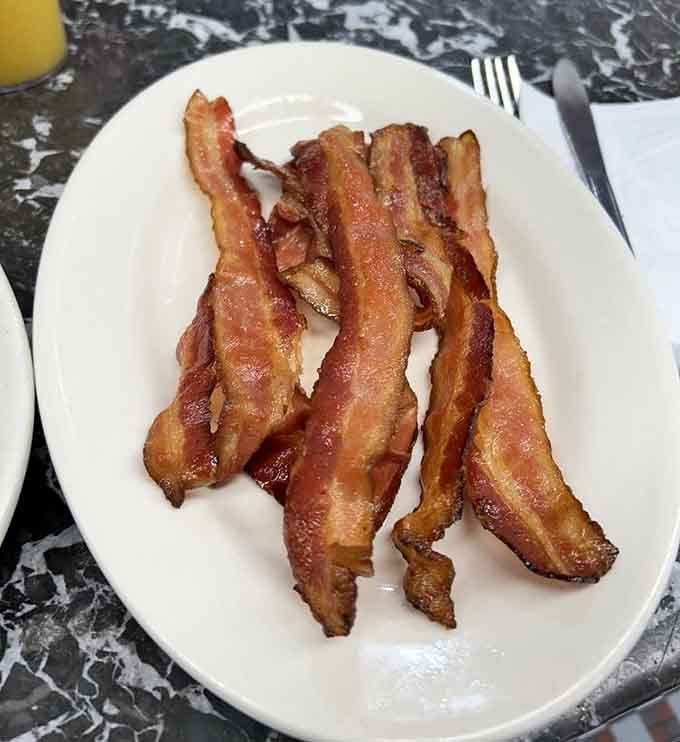 Perfectly crispy bacon that shatters at first bite, proving that simple things done right are pure magic.