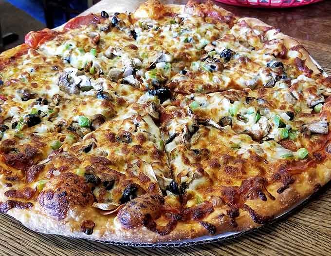 Look at that golden, bubbling cheese stretching across every inch like a delicious blanket of joy.