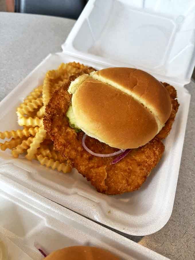 Behold, the tenderloin that launched a thousand road trips. This golden-fried masterpiece makes the bun look like it's suffering from an inferiority complex.