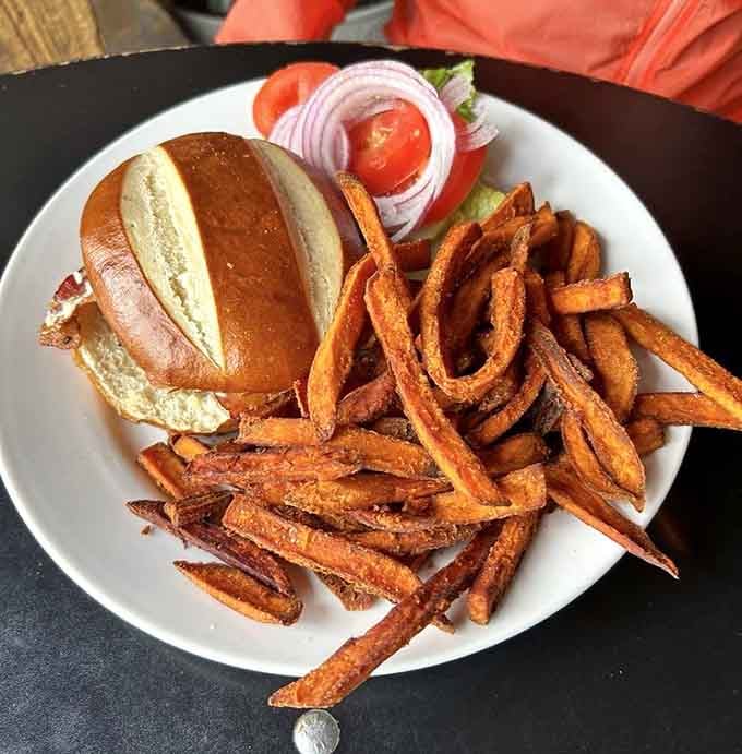 This burger arrives like a work of art, perfectly grilled and generously portioned for serious appetites.