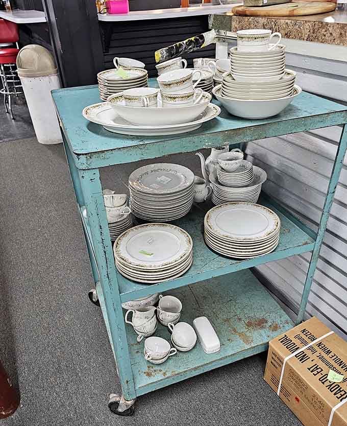 Stacks of vintage dinnerware on that turquoise cart remind you when dishes were made to last through actual family generations.