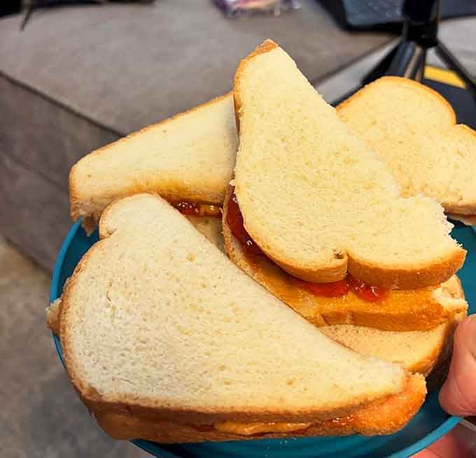 Cat-shaped peanut butter and jelly sandwiches prove that even simple snacks deserve whimsical presentation and feline flair.