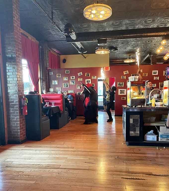 Red walls and ornate ceilings create an atmosphere that's equal parts elegant Victorian parlor and haunted mansion.