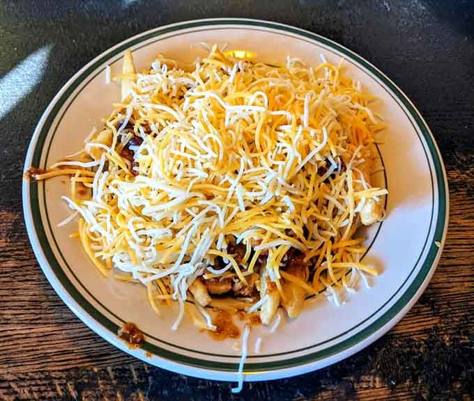 Chili cheese fries piled high enough to make your cardiologist nervous and your taste buds throw a party.