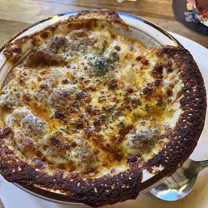 That bubbling, golden-crusted French onion soup could make a vegetarian reconsider their entire philosophy, at least for one glorious meal.