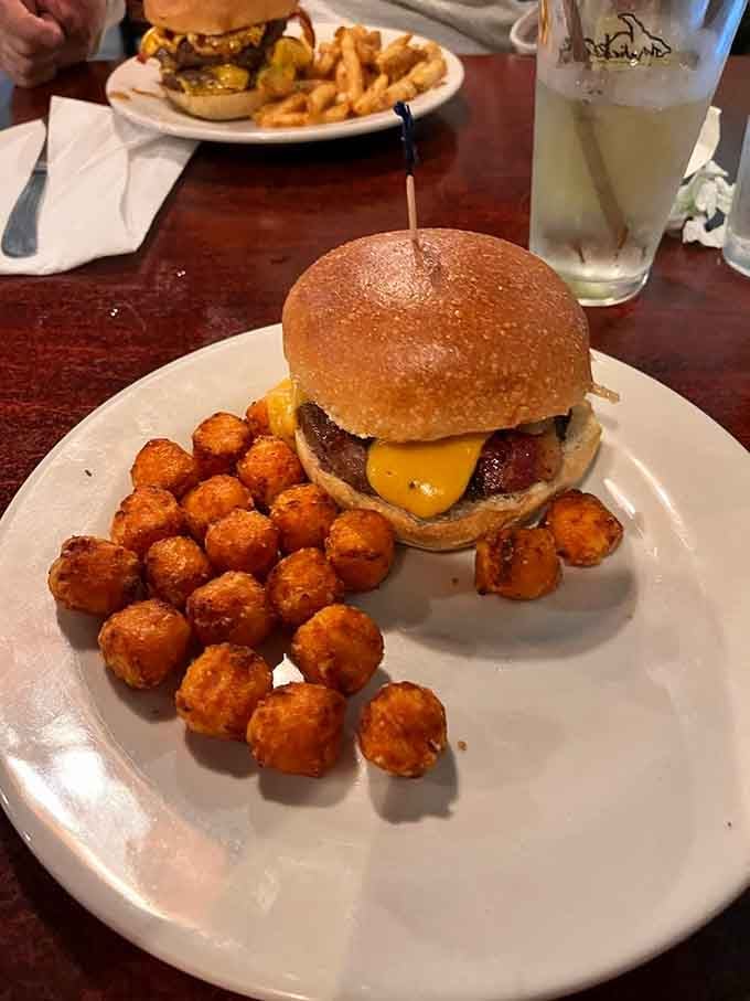 The Drunken Cow arrives with tater tots and proves that some burgers require a full commitment strategy.
