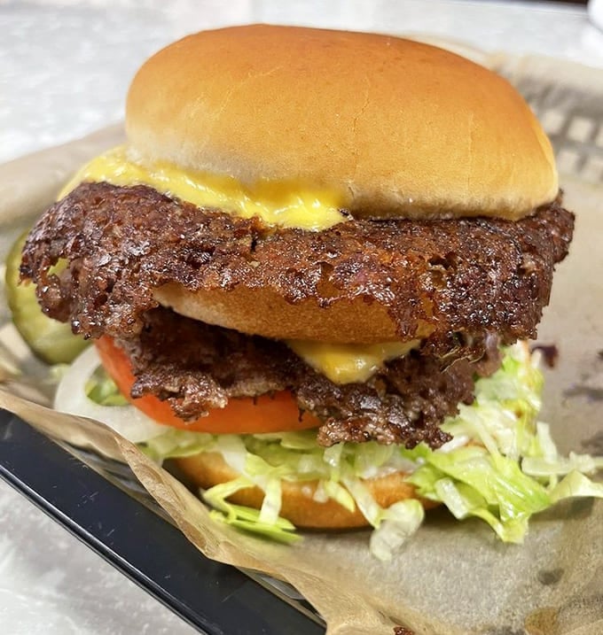 Two thin patties with crispy edges and melted cheese—this is burger architecture at its finest, folks.