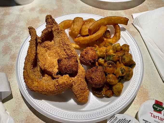 Golden catfish, crispy okra, and onion rings create the holy trinity of Southern fried perfection on one plate.
