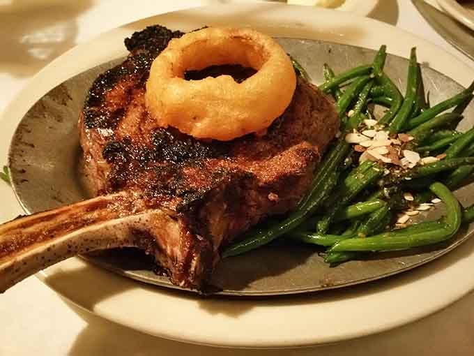 The Ribeye arrives with an onion ring crown because sometimes royalty needs proper accessories at the dinner table.