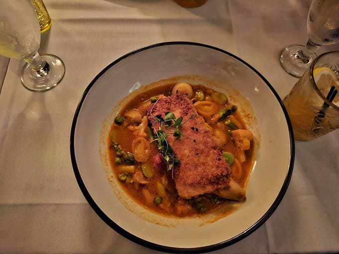 Perfectly seared salmon nestled in a savory broth proves that vault dining doesn't mean sacrificing flavor or finesse.