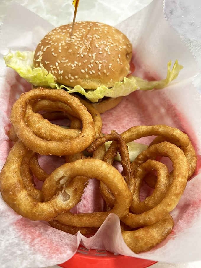 Golden onion rings circling a burger like Saturn's rings, except infinitely more delicious and way less gassy.