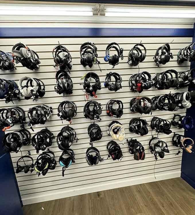 A wall of headphones that looks like a DJ's fever dream, all tested and ready for new ears.
