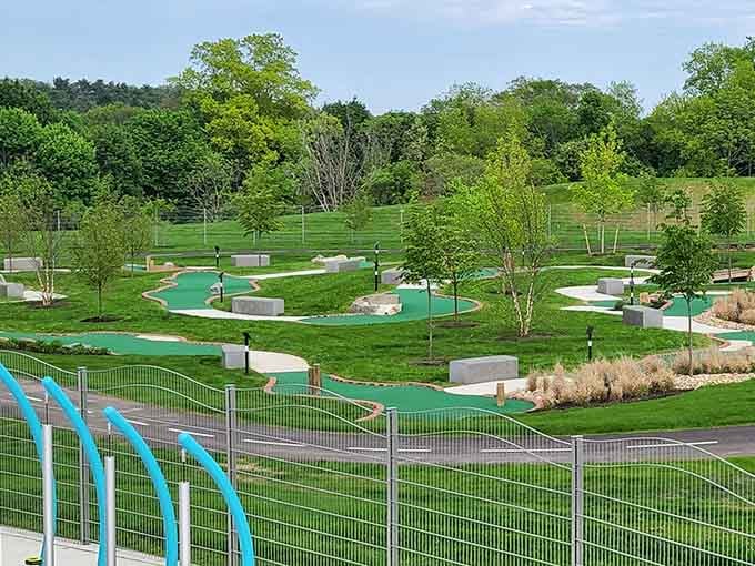 Mini golf that actually looks fun instead of windmill-themed torture, nestled in genuine grass like nature intended.