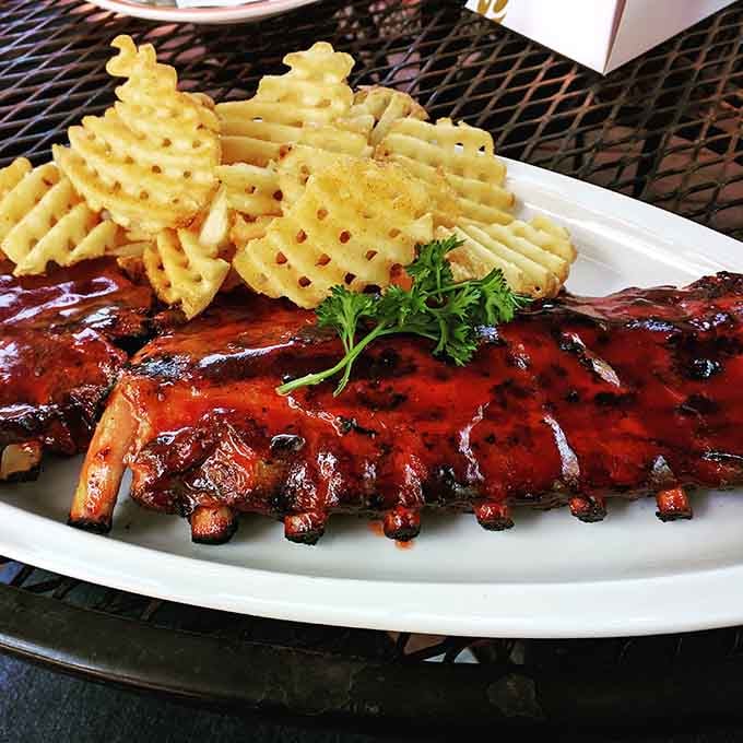 Behold the platonic ideal of ribs: glazed, gorgeous, and served with waffle fries that deserve their own fan club.