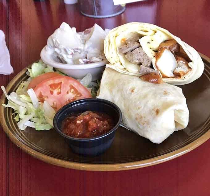 That breakfast burrito is stuffed so generously, you might need a strategic plan and possibly a nap afterward.