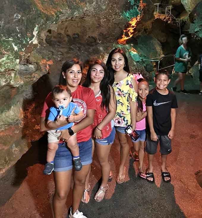 Nothing says family bonding quite like posing together inside a fault line illuminated by otherworldly colored lights.