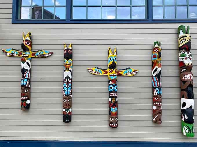 Totem poles lined up like a Pacific Northwest version of Mount Rushmore, minus the presidential egos.