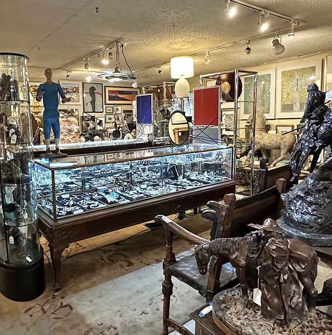 A treasure hunter's paradise! Glass display cases filled with jewelry and collectibles, surrounded by sculptures that seem to whisper stories from another time.