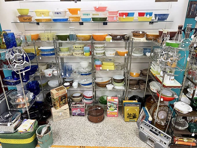 Pyrex paradise! The colorful vintage bowls and containers are arranged like a mid-century rainbow, triggering instant nostalgia for grandma's kitchen.