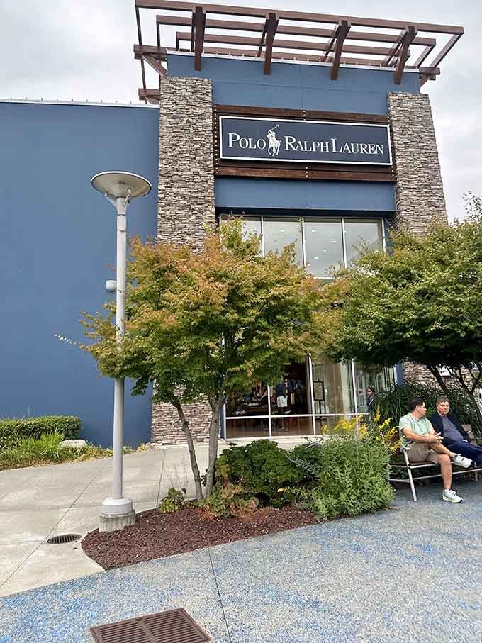 The Polo Ralph Lauren storefront stands like a fashion embassy, complete with stone accents and benches for weary shopping companions.