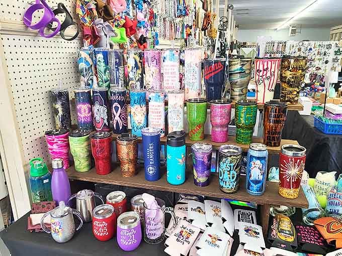 Colorful tumblers and travel mugs stand ready for adoption, their previous lives as corporate gifts now forgotten in favor of new adventures.