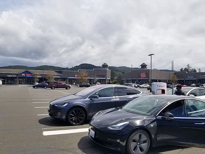 Electric vehicles charging up while their owners charge through the stores&mdash;modern convenience meets retail therapy perfectly.