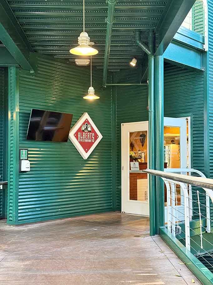 Turquoise corrugated metal never looked so inviting, framing an entrance that promises adventure beyond those doors.