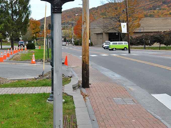 Brick sidewalks lead past colorful storefronts where autumn leaves dance like confetti celebrating the changing seasons.