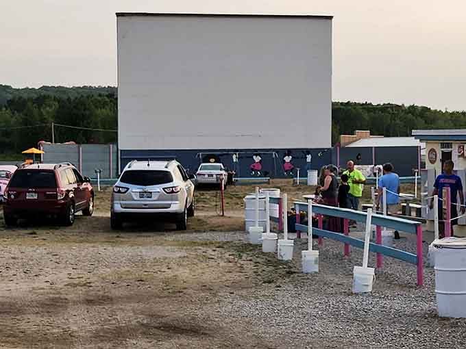 The cheerful pink and white fencing guides moviegoers toward an evening of entertainment and buttered popcorn dreams.