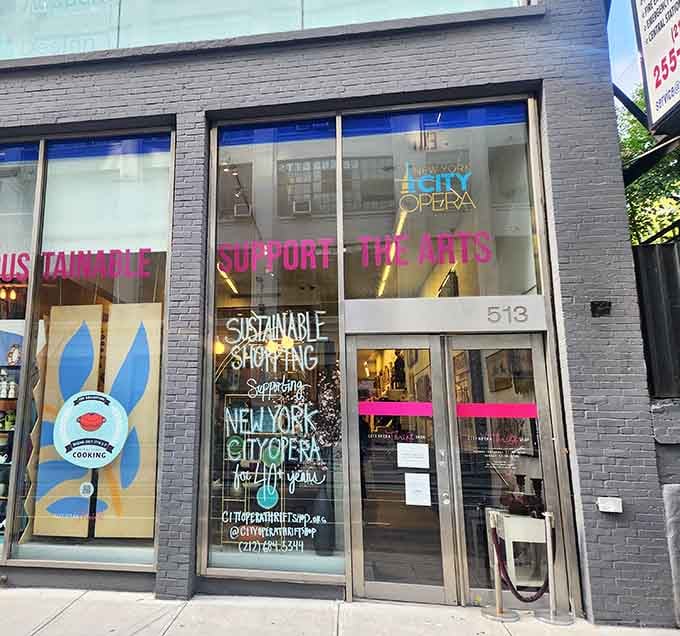 The modern gray facade and colorful window messages prove that thrift shopping can support the arts in style.