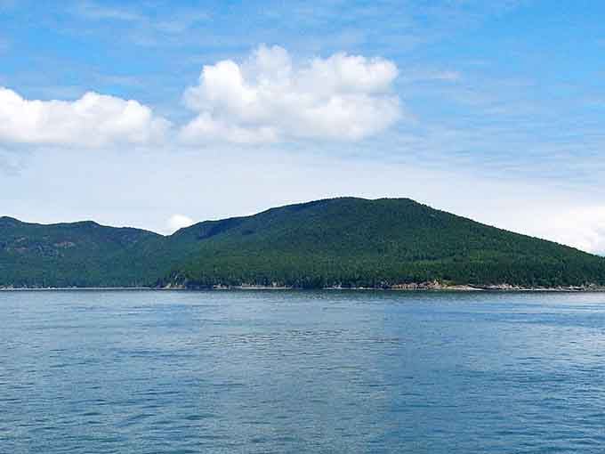 That mountain rising from calm waters has the kind of presence that makes you want to cancel all your plans.