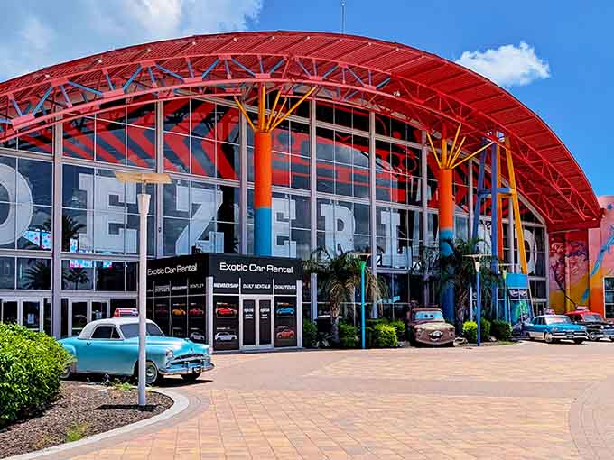 That dramatic red roof arches over a wonderland where classic cars meet modern thrills in perfect harmony.