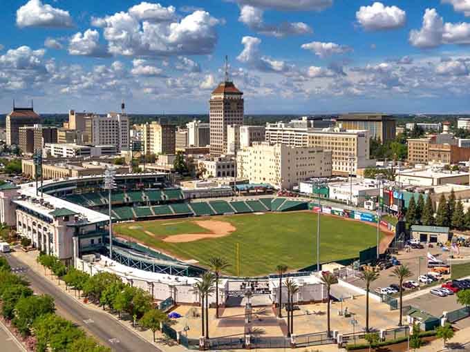 The baseball stadium sits nestled in the city skyline, ready for summer nights and hot dogs.
