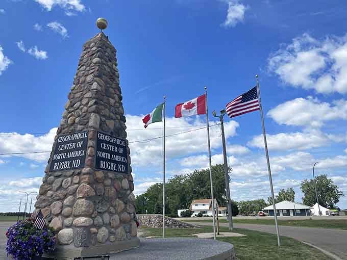 Three flags flutter above this humble obelisk marking the continental midpoint&mdash;the ultimate geographical bragging right.