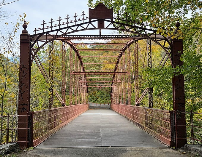 This historic bridge frames autumn's glory like a rustic picture frame, connecting you to adventures on the other side.