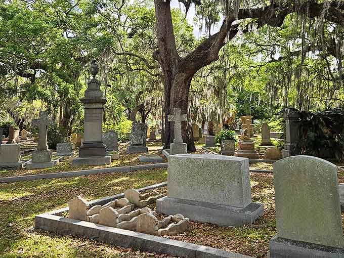 Spanish moss drapes these monuments like nature's own curtains, creating an atmosphere straight from a Southern Gothic novel.