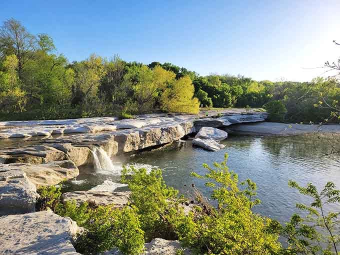 The river tumbles over ancient limestone in layers, creating a natural staircase that's been millions of years in the making.