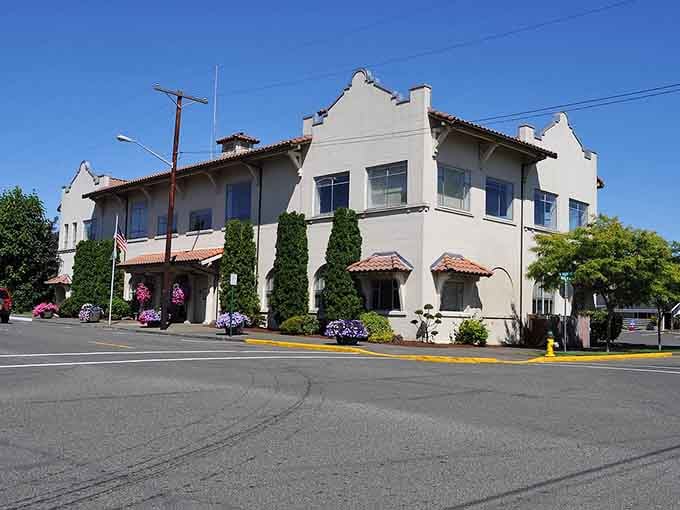 Spanish Colonial Revival elegance blooms with hanging baskets, proving small towns can have serious architectural style.