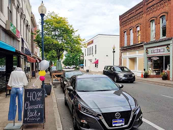 Local shops line streets where a 40% off sale still gets handwritten on a chalkboard sign.