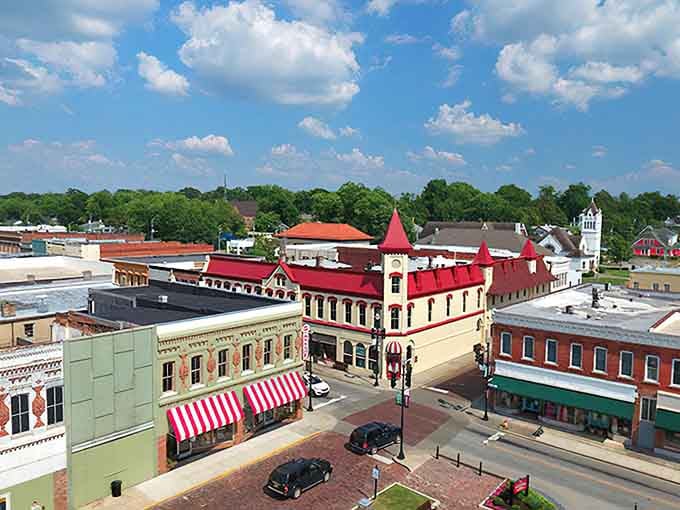 That red-roofed building with the tower looks like something from a storybook, anchoring a perfectly preserved square.